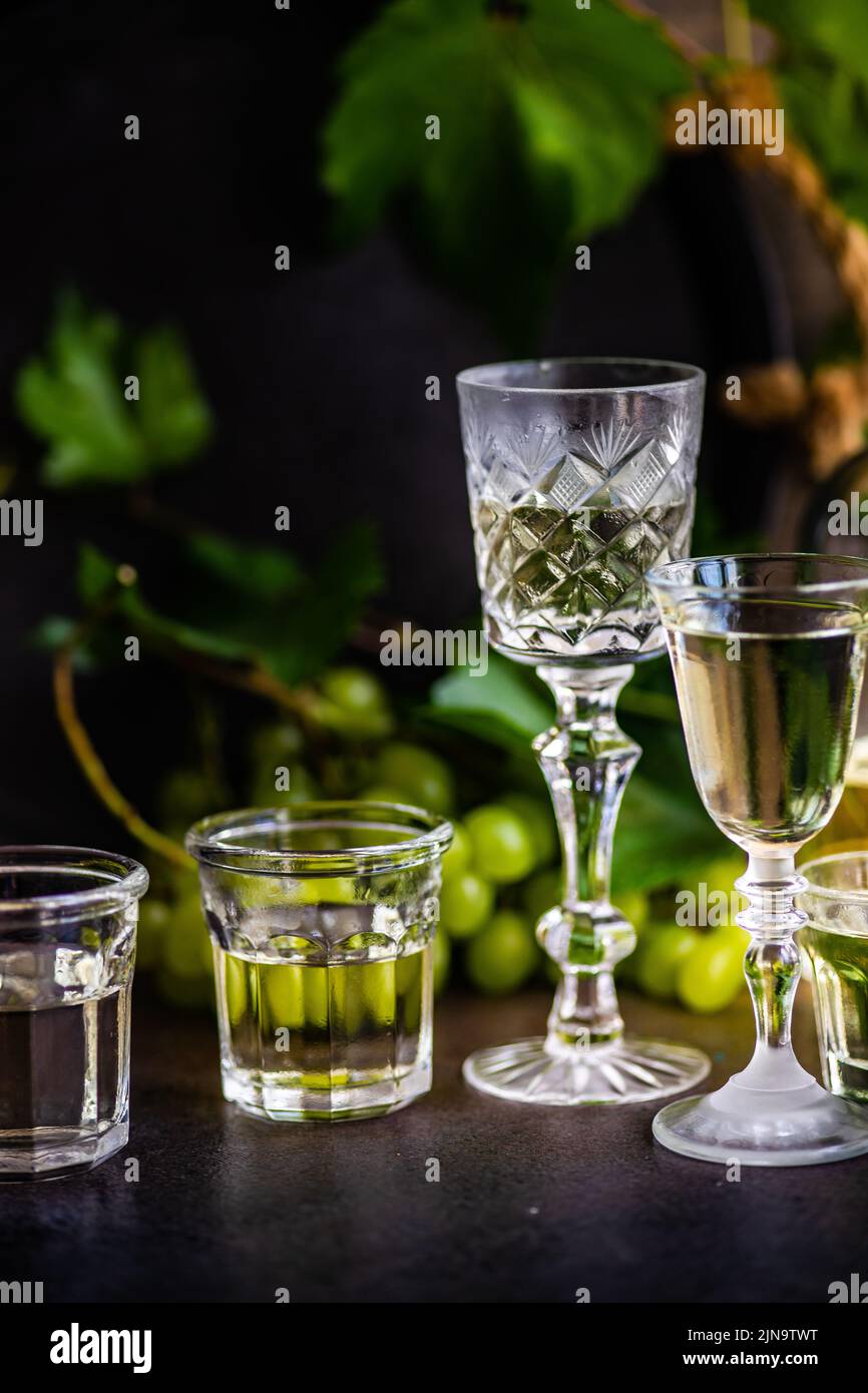 Georgian grape chacha drink in the bottle and glasses on dark rustic ...