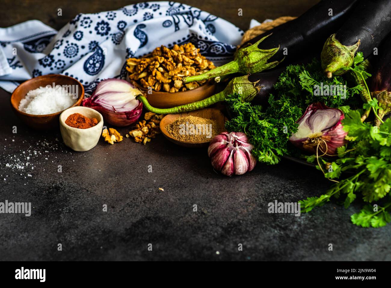 Cooking of famous Georgian dish from eggplants with walnuts on dark ...