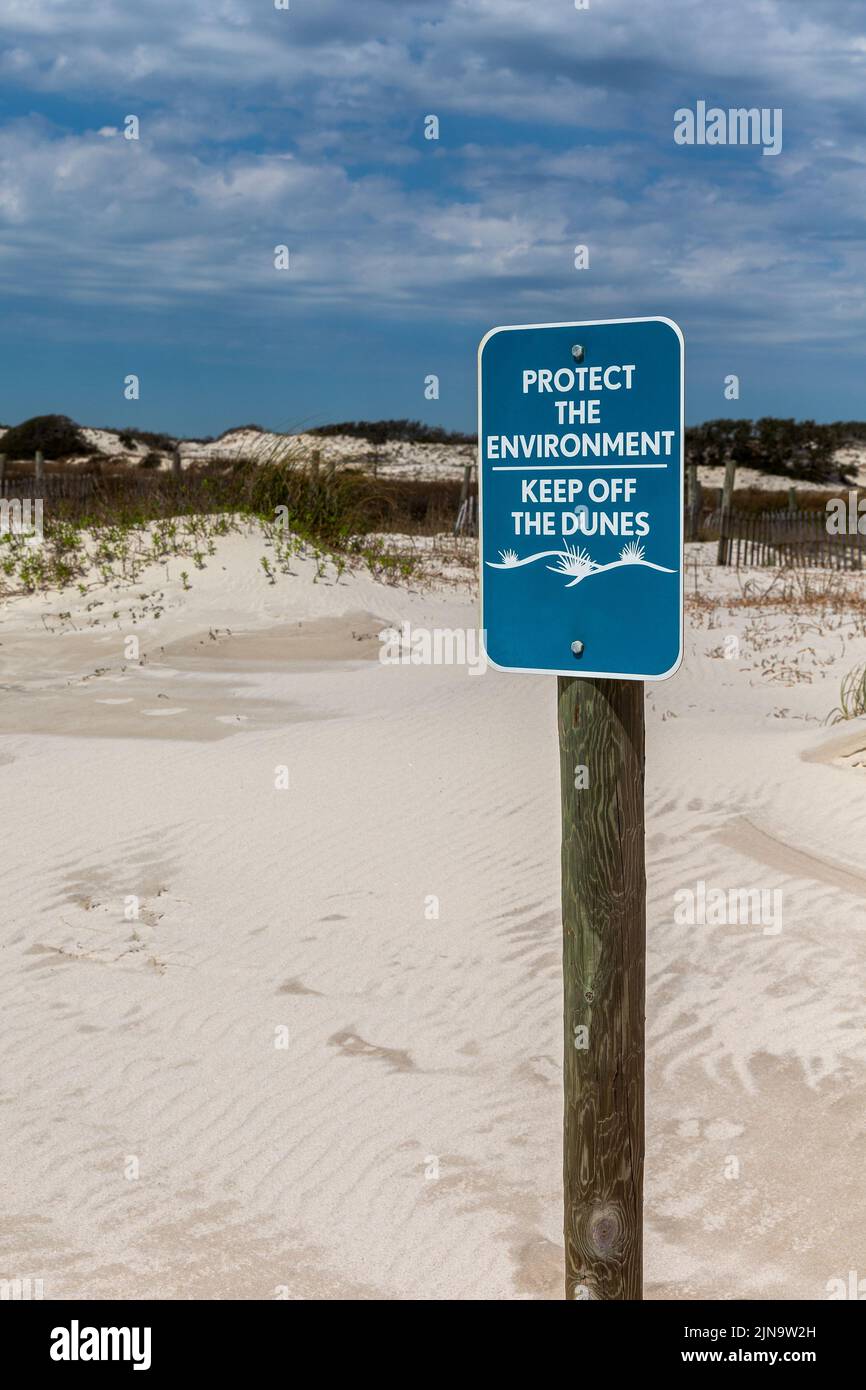 Sign instructing visitors to keep off the sand dunes in order to ...