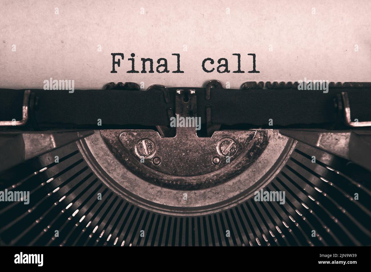 Final call words typed on an old vintage typewriter in black and white ...