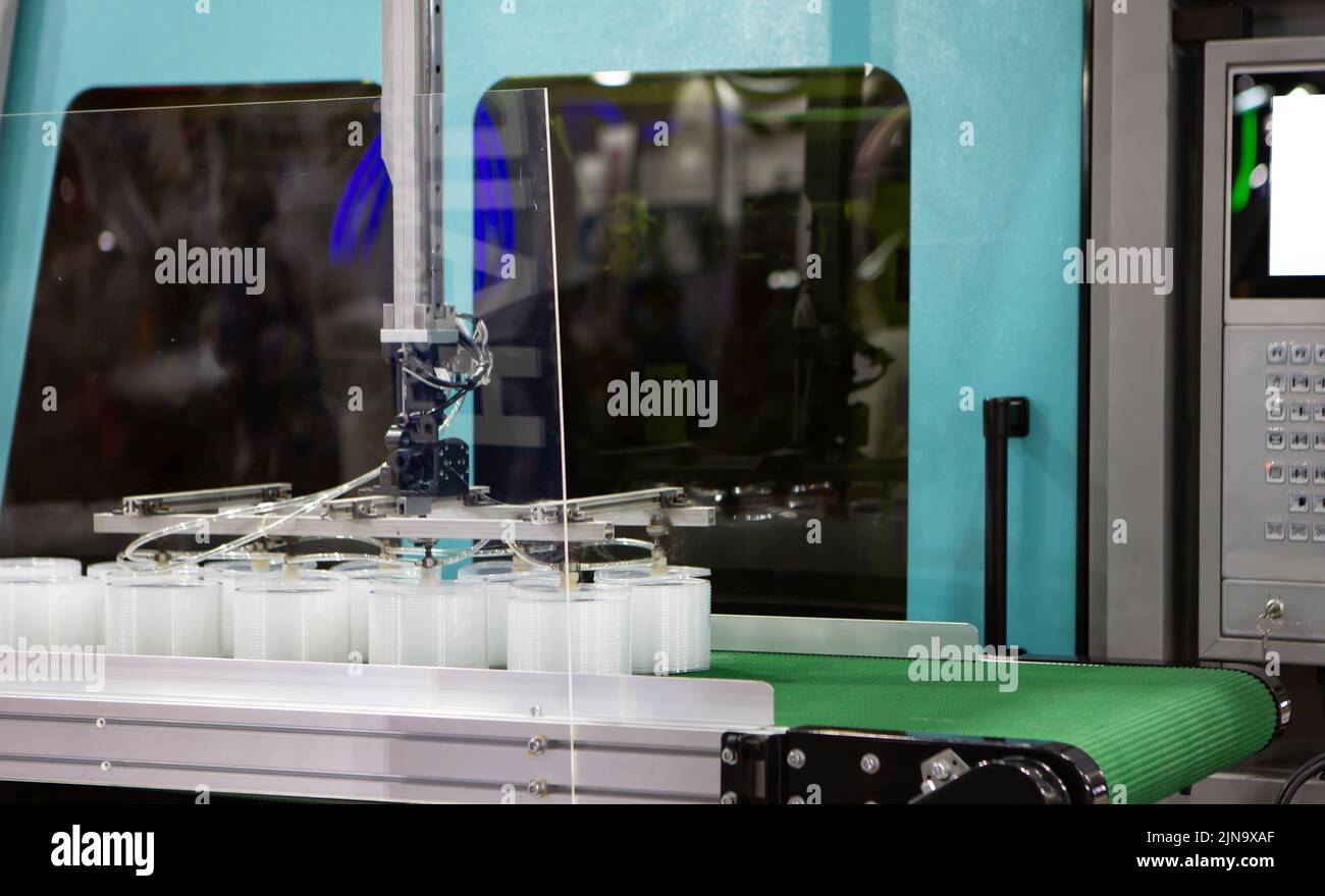 Robot moving finish products from molding press machine. Industrial ...