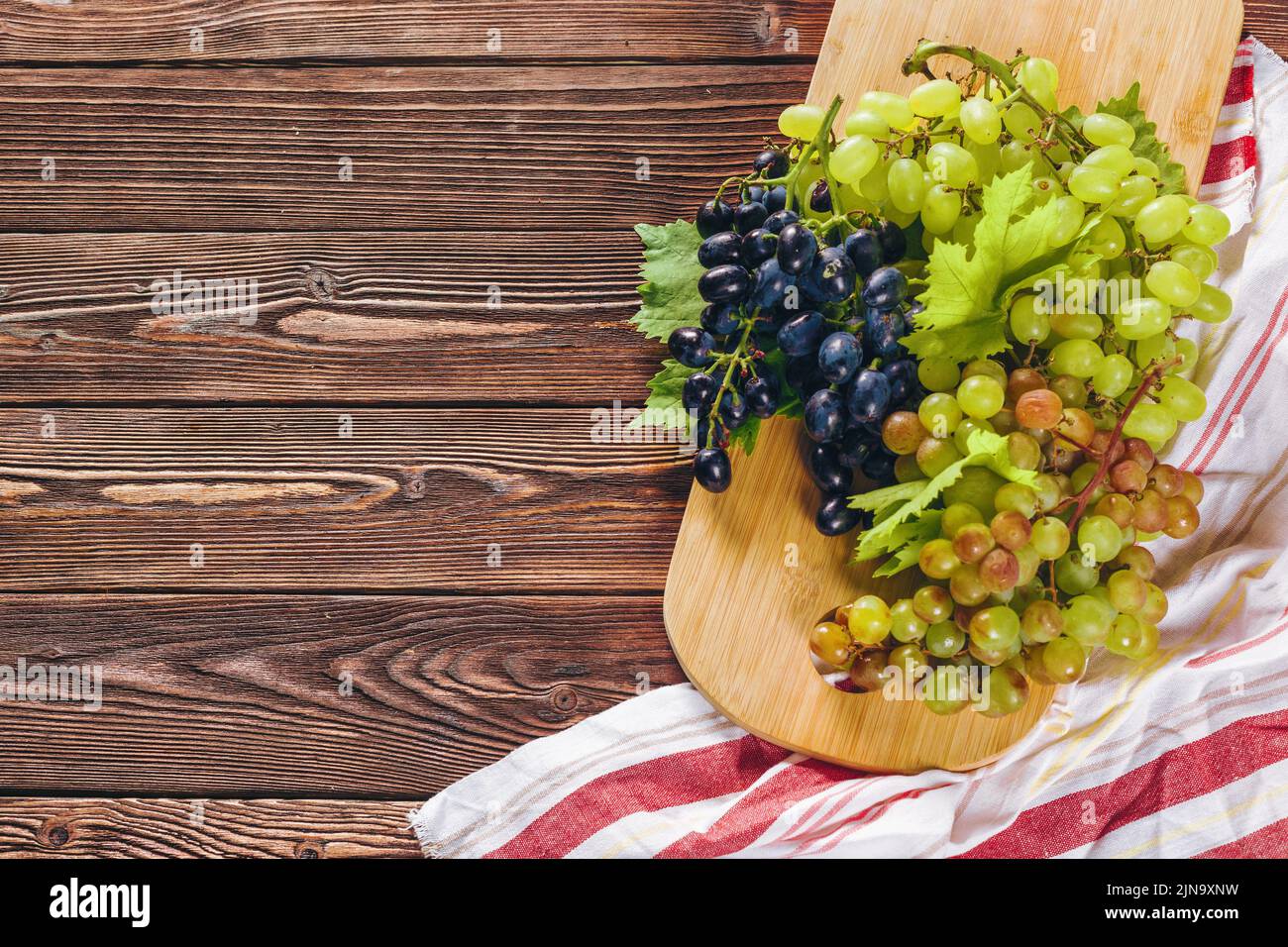 Grapes on a wooden table Stock Photo - Alamy