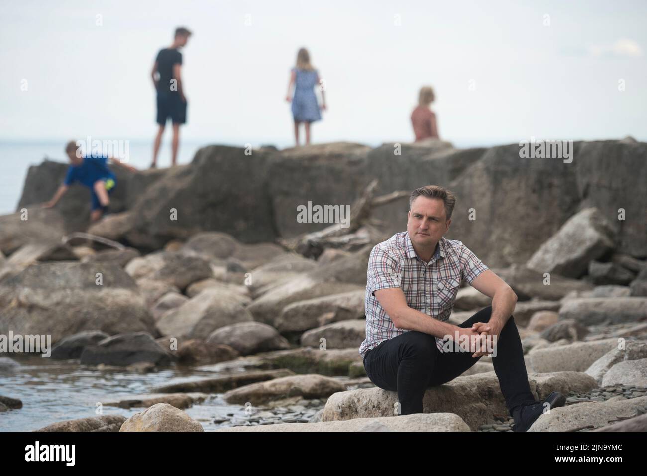 Myron Genyk poses for a photograph while out on the lakeshore with his ...