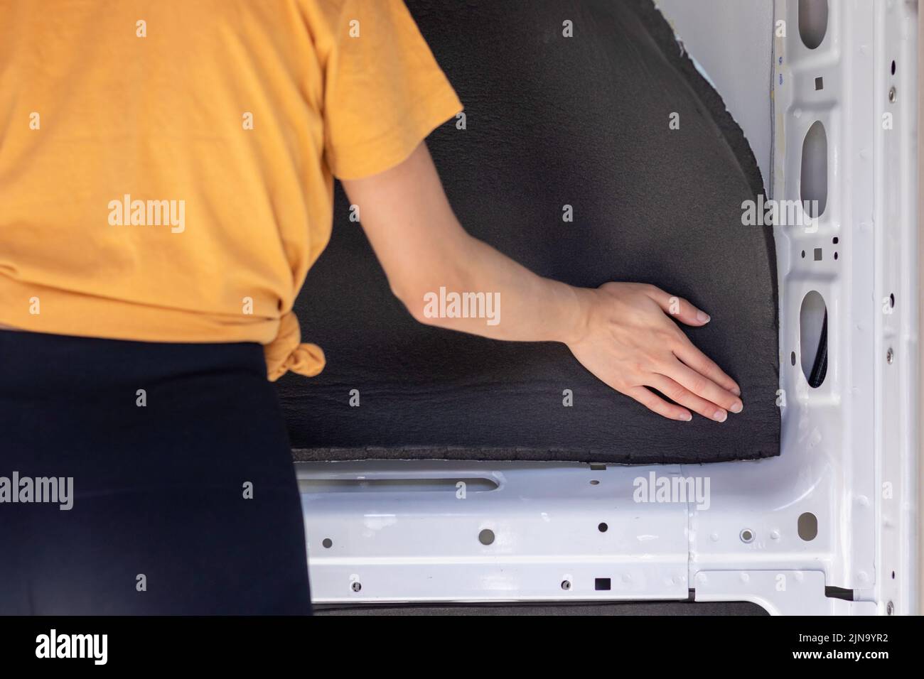 Close up view of unrecognizable young woman building a self made RV ...