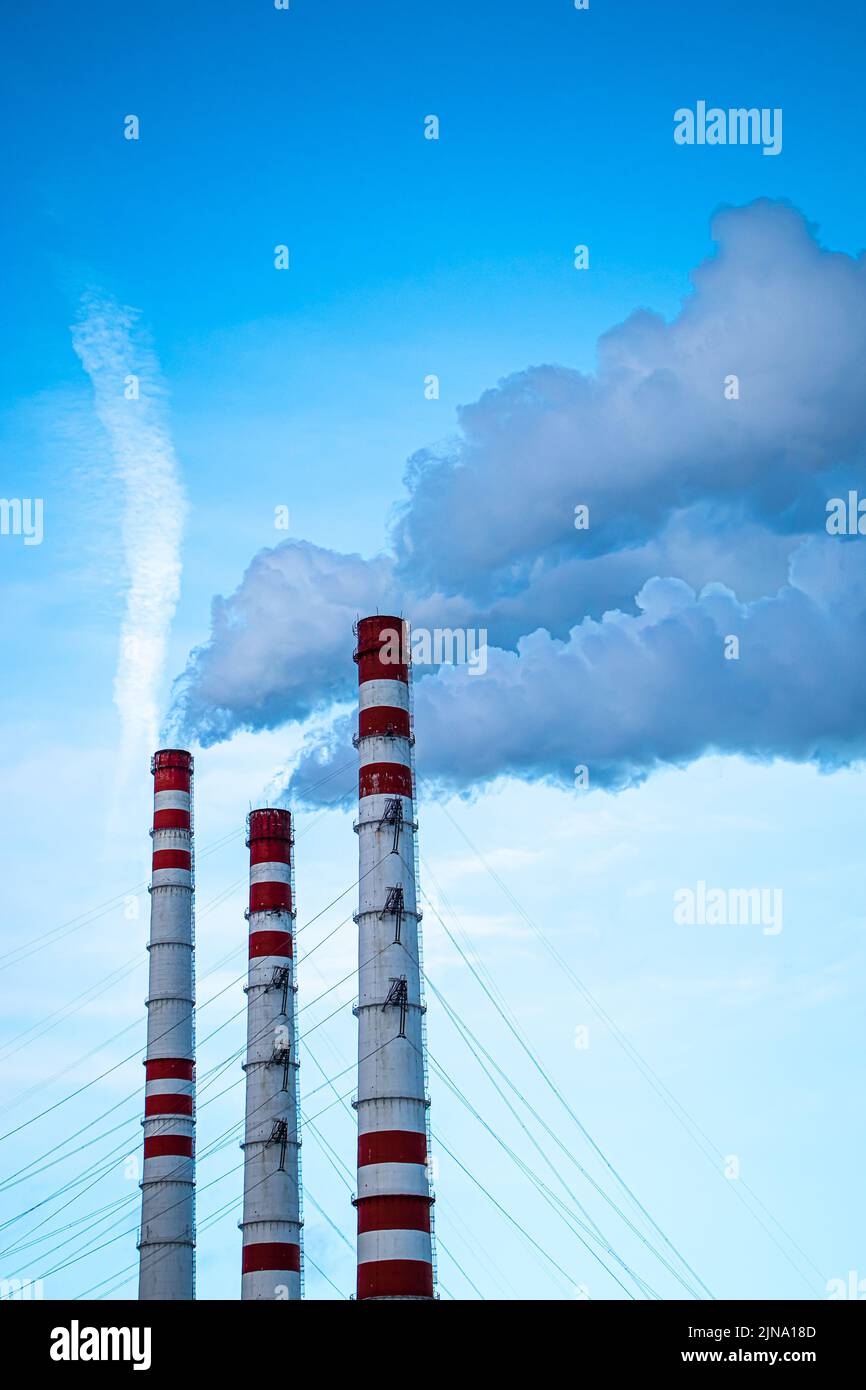 Air pollution. Thick smoke from chimneys in industrial plant ...