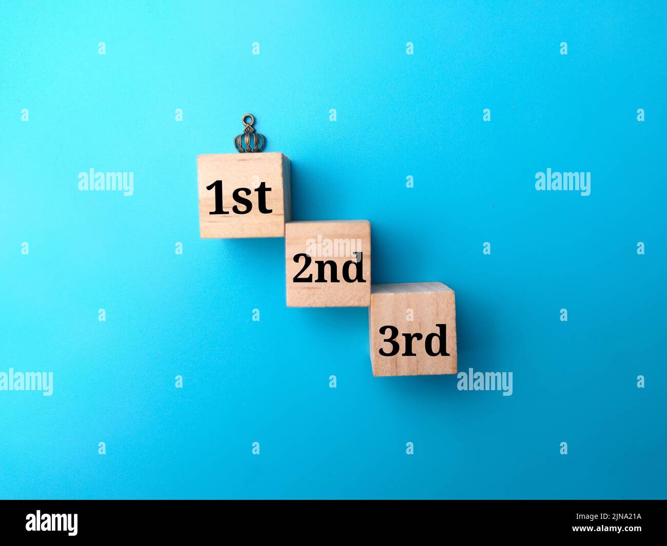 A wooden block with the numbers 1st, 2nd, and 3rd on blue background ...