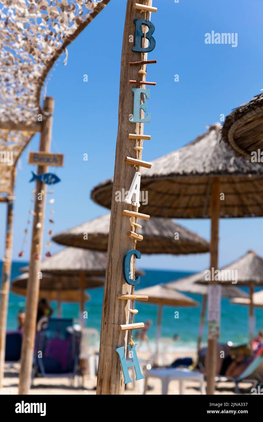 Beach sign. Wooden letters hanging from a post at beach bar Stock Photo ...