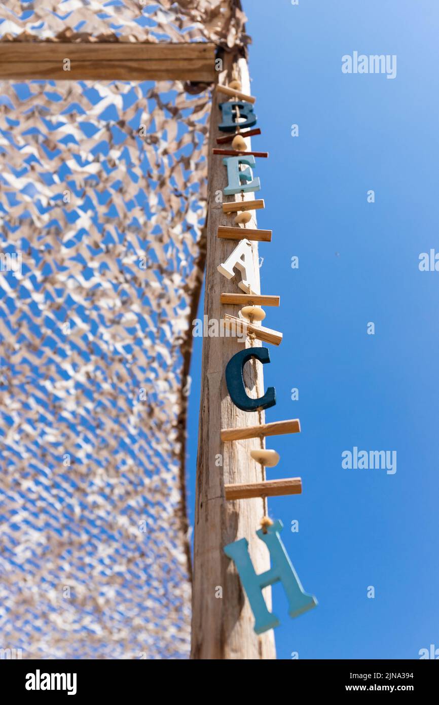 Beach sign. Wooden letters hanging from a post at beach bar Stock Photo ...