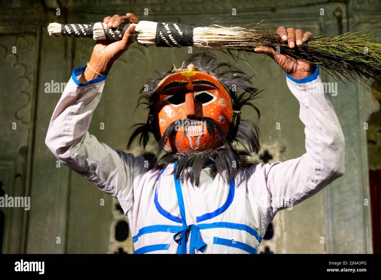 An Indian man with a mask performing during the Dharohar Folk Dance ...