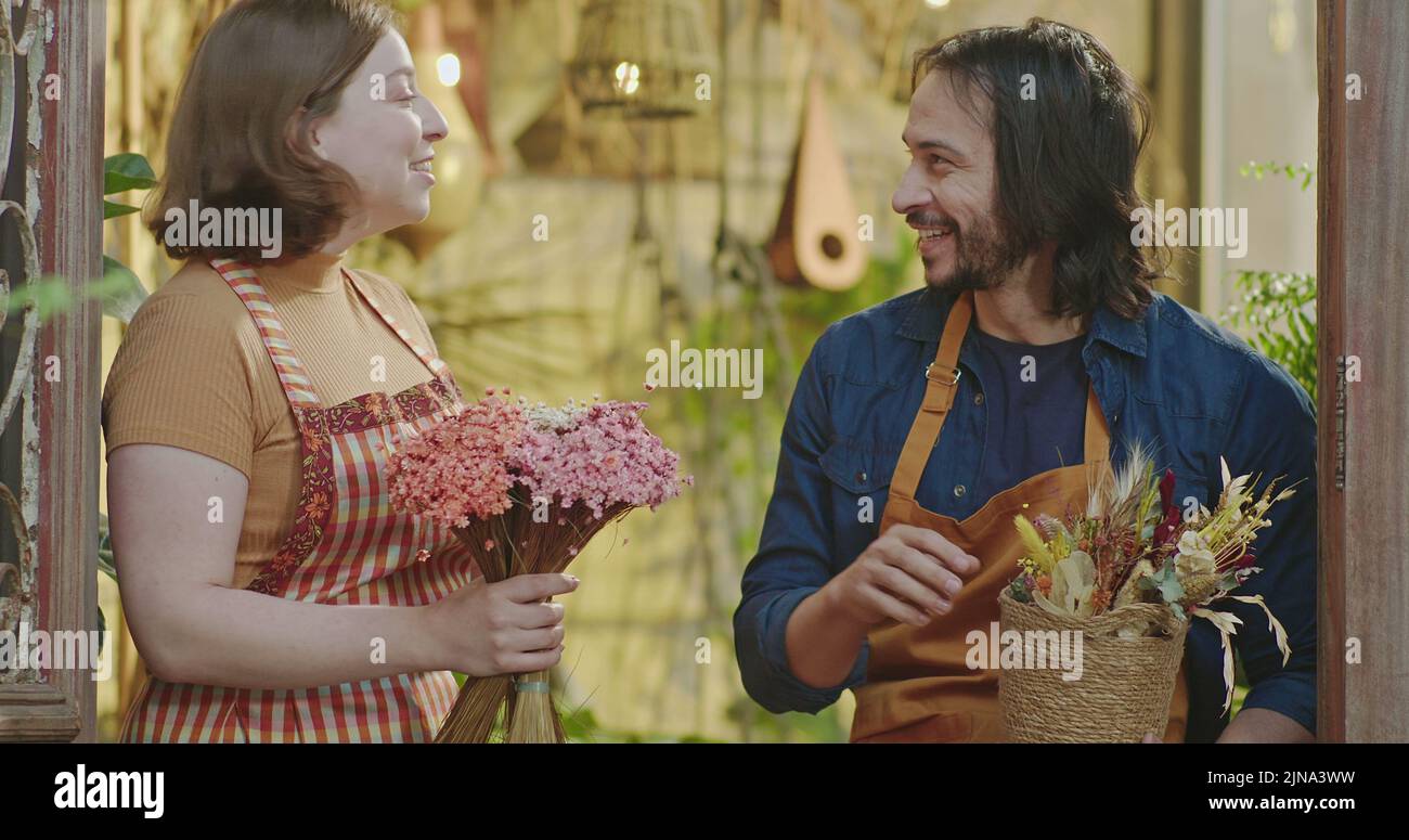 Male and female workers smiling and laughing at camera. Portrait of two ...