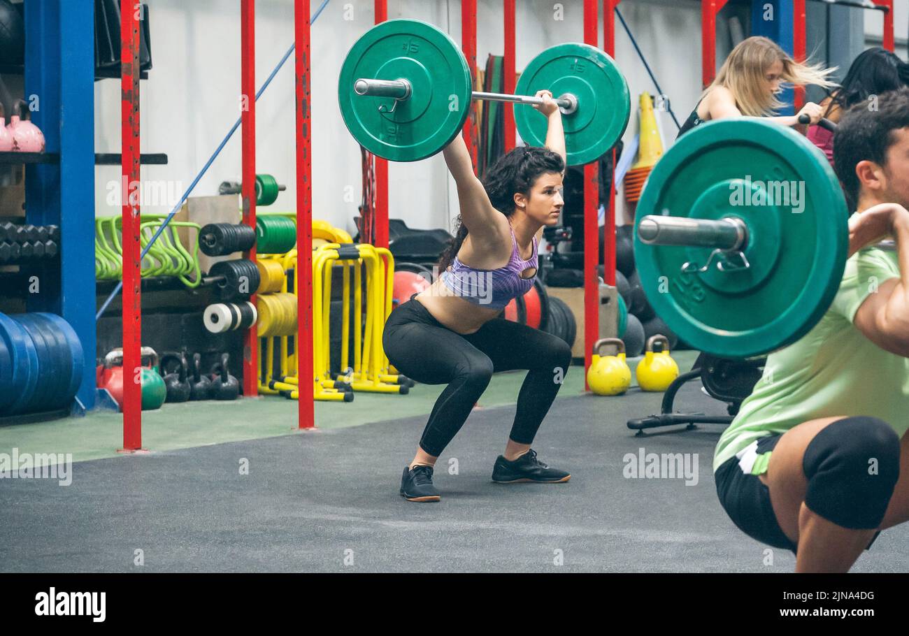 Woman practicing weightlifting in the gym Stock Photo - Alamy