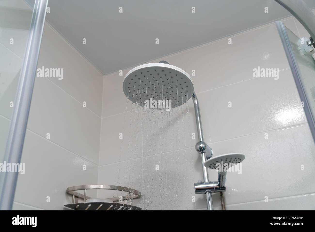 Rain shower with running water in a bright bathroom Stock Photo - Alamy
