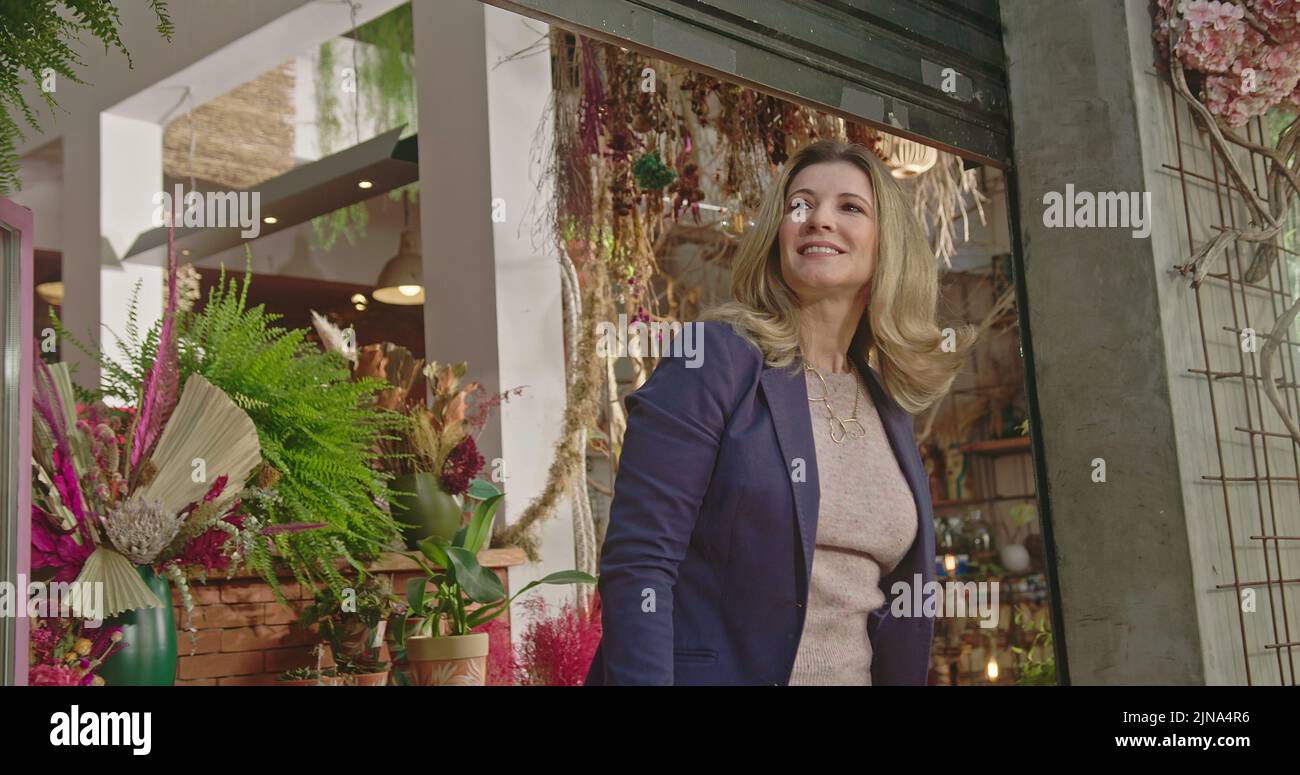 Small business owner opening local store. Female entrepreneur sliding ...