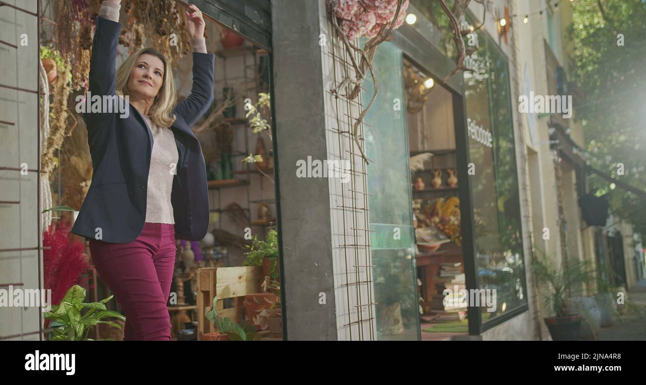 Small business owner opening local store. Female entrepreneur sliding ...