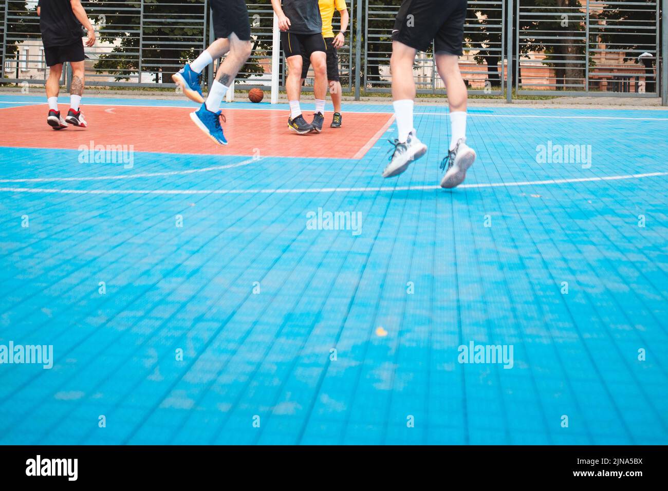 men playing basketball outdoors crop Stock Photo - Alamy