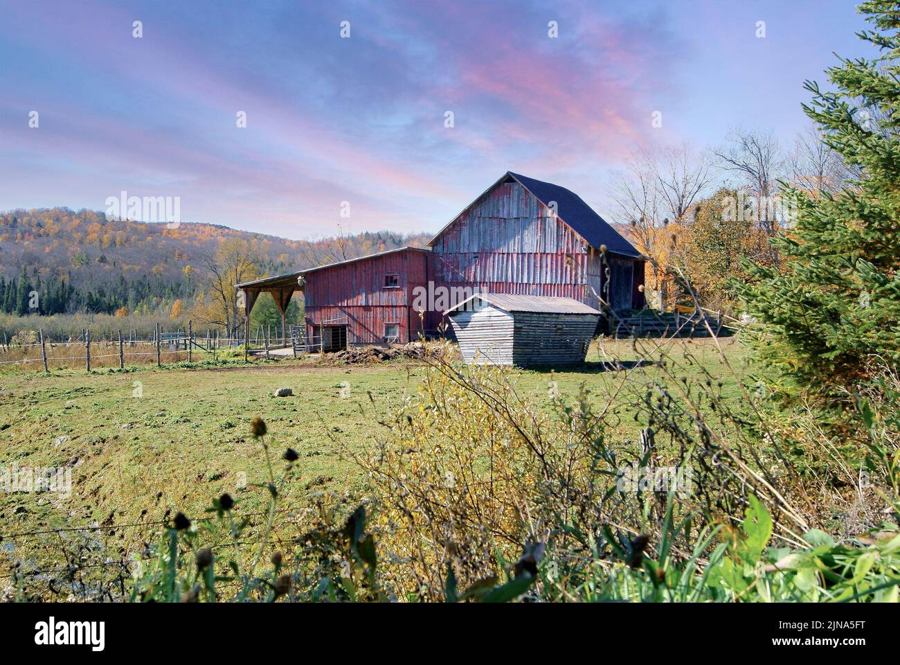 old red barn with the sunset on the clouds above Stock Photo - Alamy