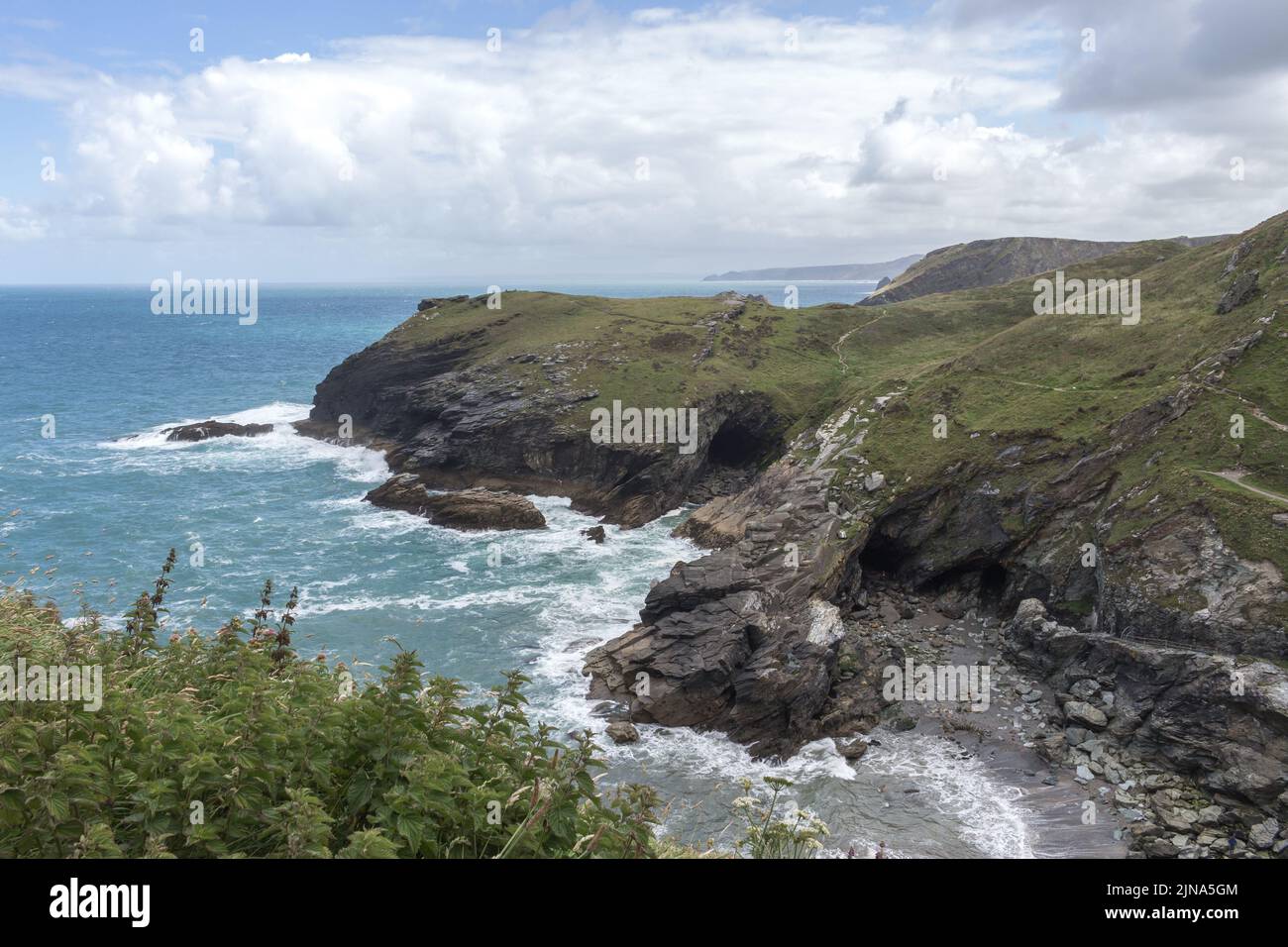 Foamy waves rushing to scenic cliffs, Cornwall coast, UK Stock Photo ...