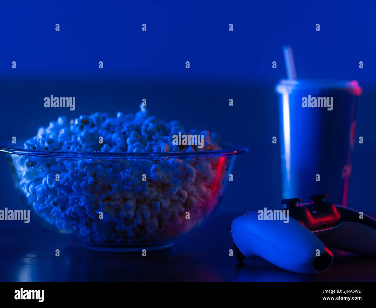Video games with fast food. On the table is a glass bowl of popcorn, a ...