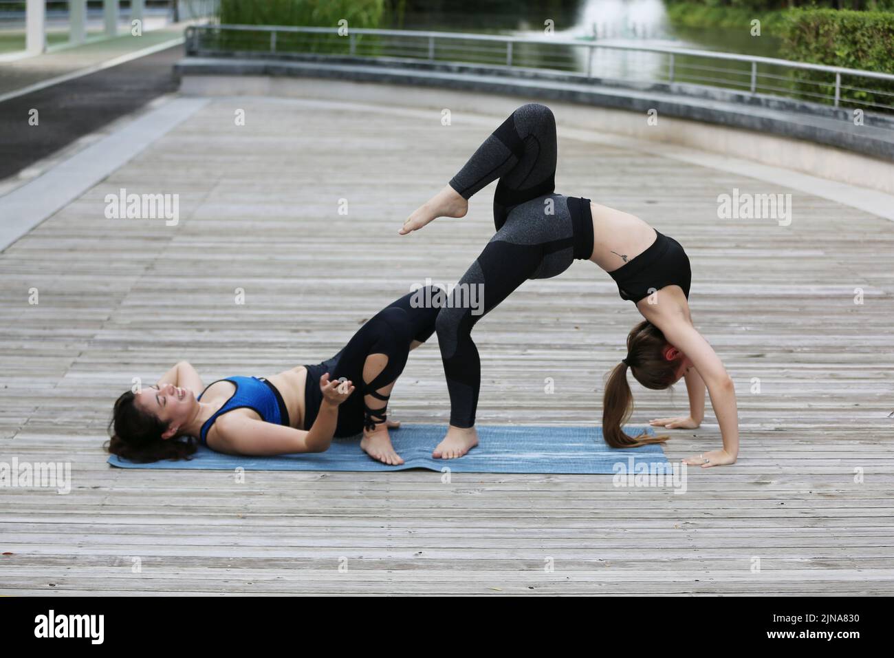 Young sporty attractive woman practicing yoga, doing yoga exercise with ...