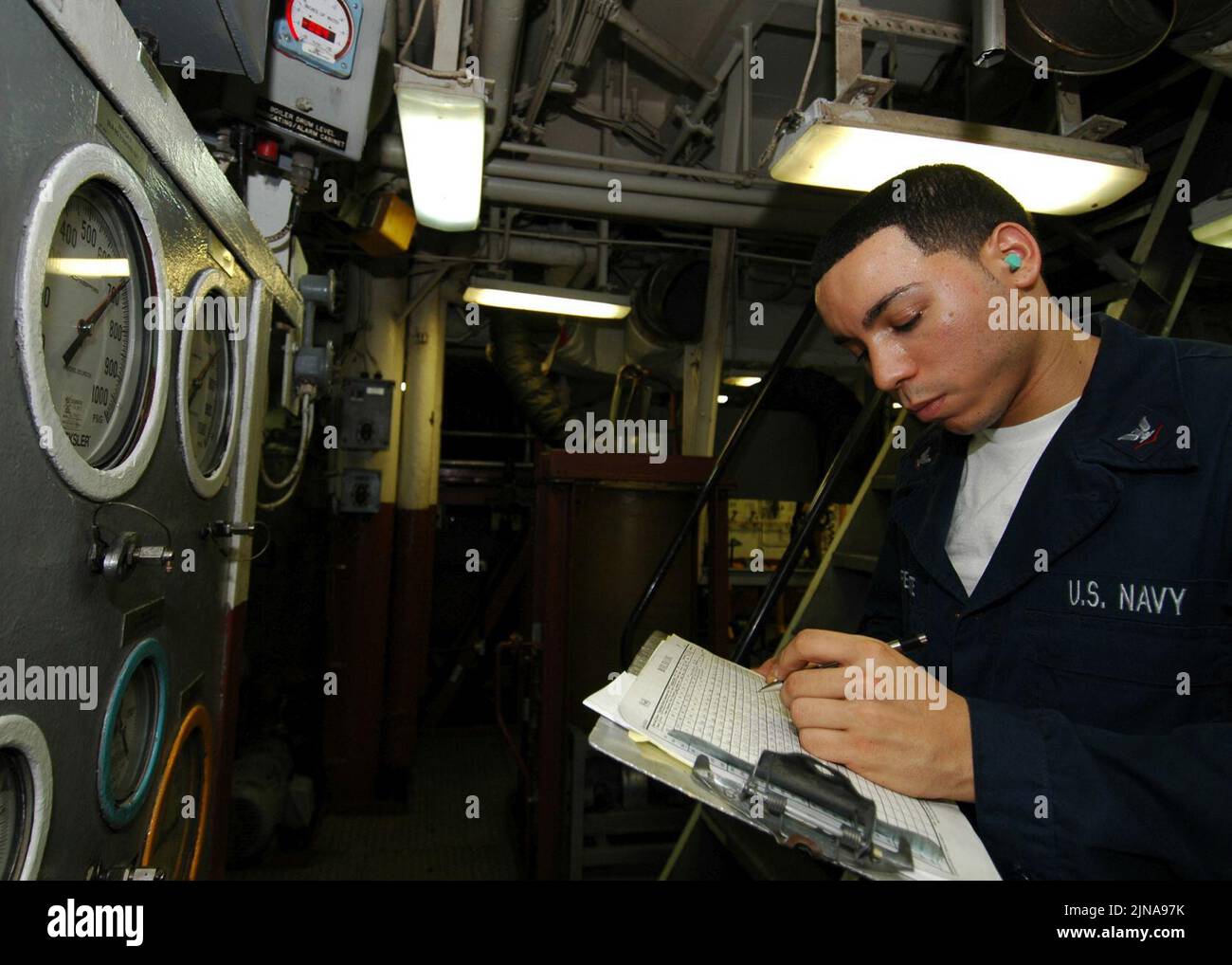 Taking readings in USS Iwo Jima engine room Stock Photo - Alamy