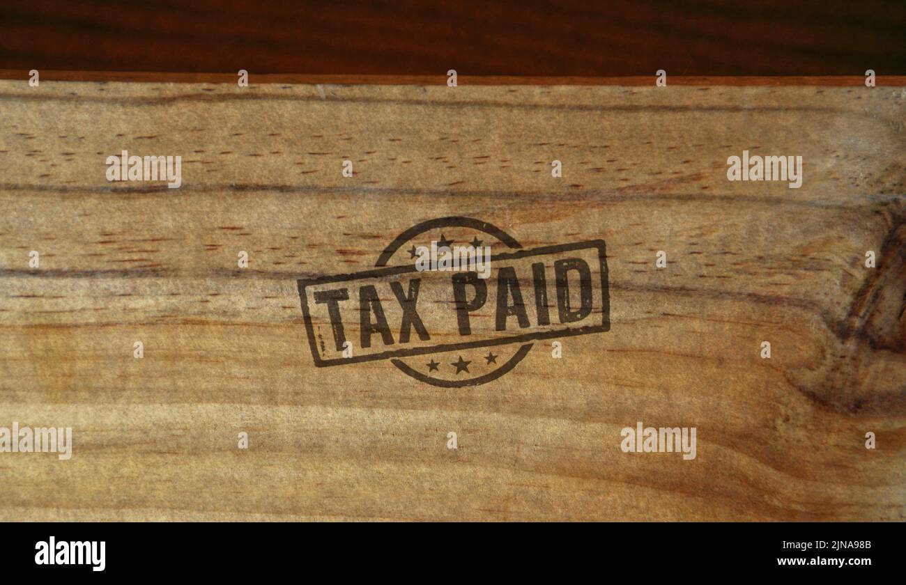 Tax paid stamp printed on wooden box. Business taxes and income ...