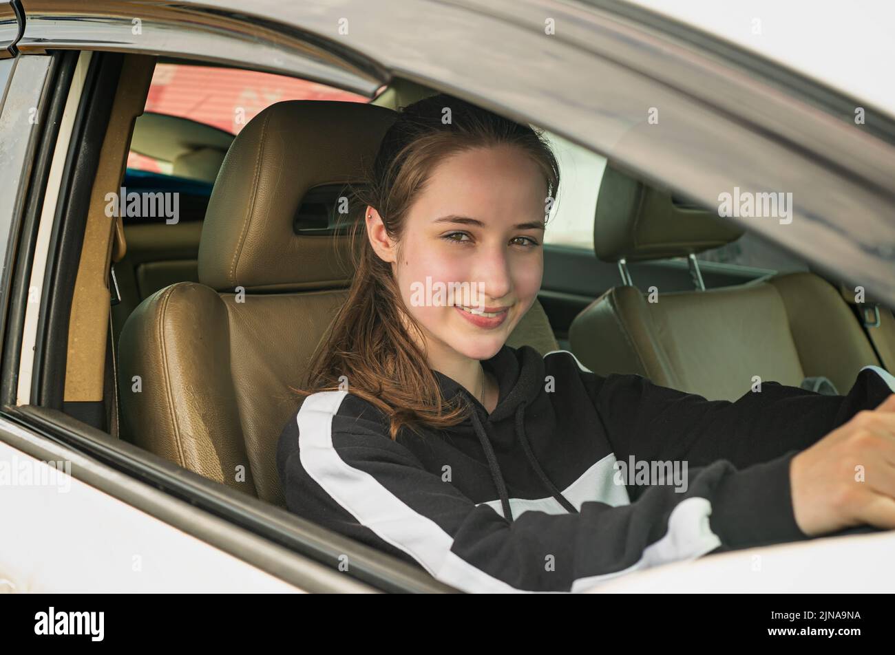 Happy woman driving a car and smiling. Cute young success happy ...