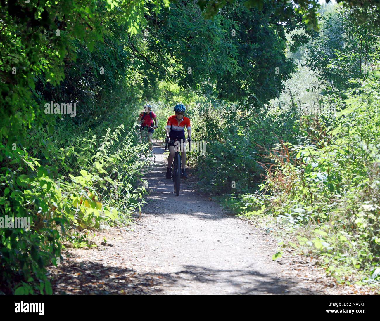 Two cyclists enjoy the Ely Trail, Cardiff. August 2022. Summer Stock ...