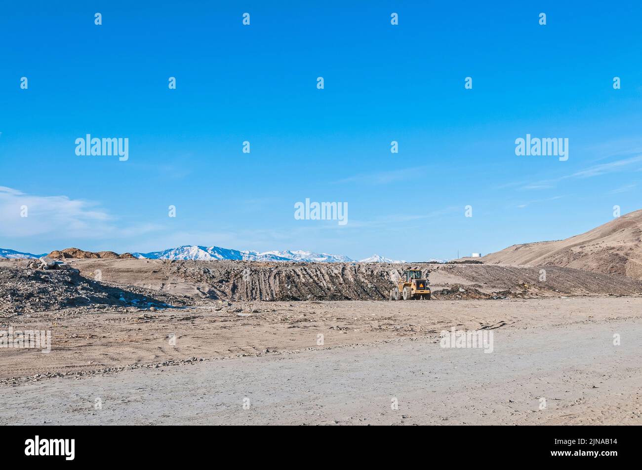 A weathered yellow bulldozer is parked in the distance at an active ...