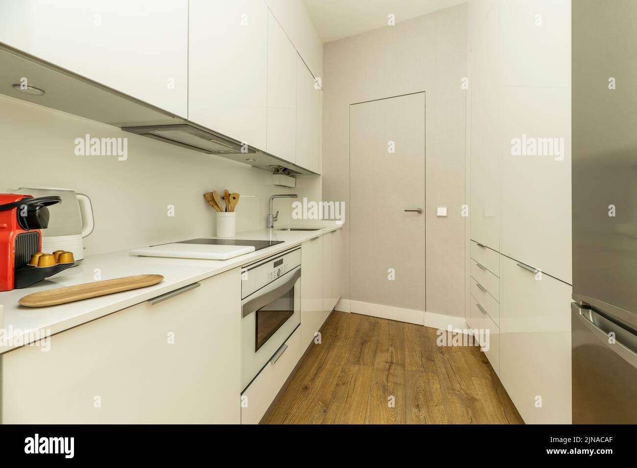 Small kitchen with white furniture and matching appliances with ...