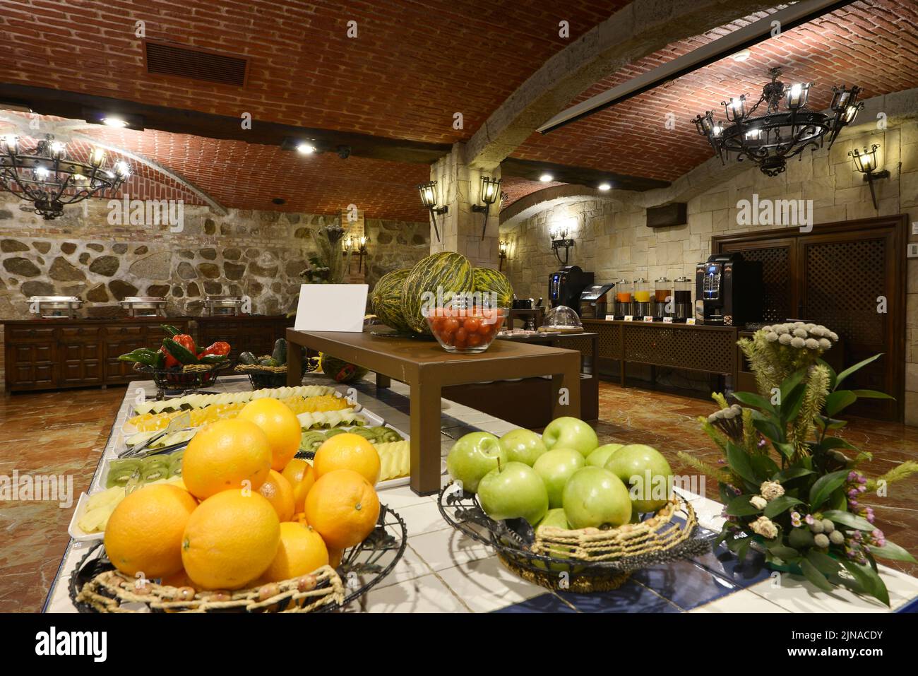 dining room of a hotel with baskets full of pieces of fruit and chopped ...