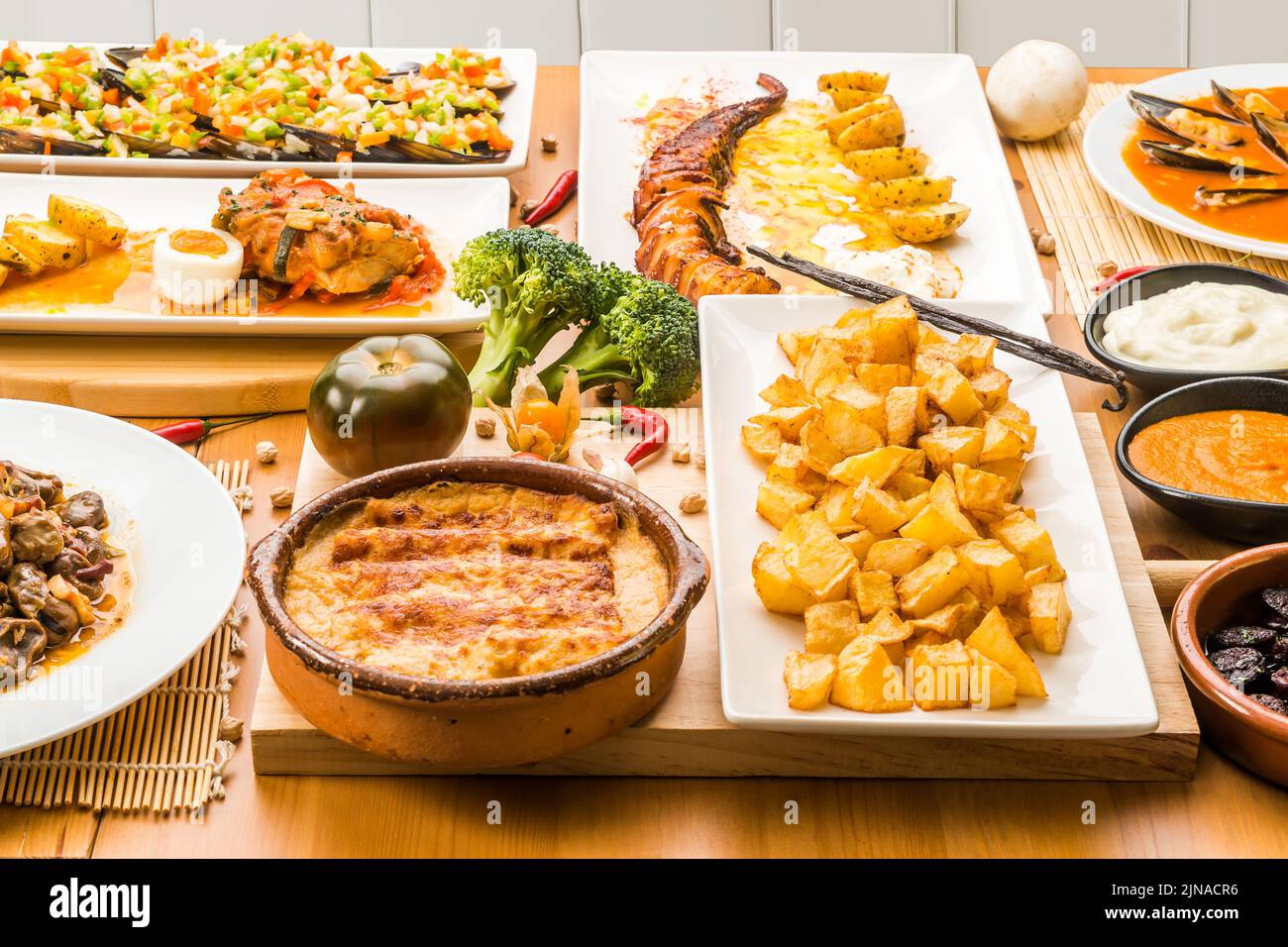 Broccoli among several prepared dishes of typical Spanish food Stock ...