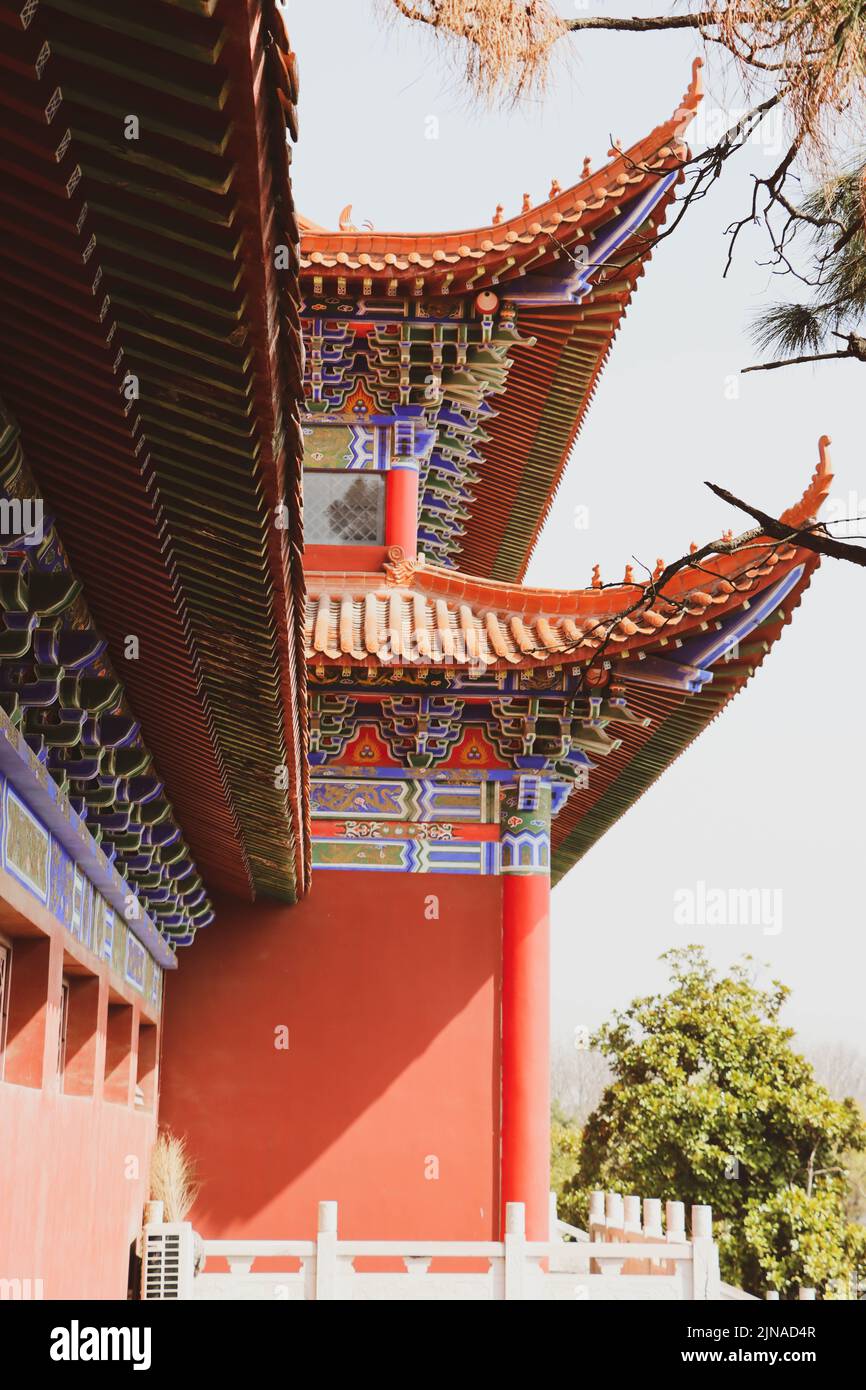 A vertical shot of a Chinese traditional temple with a beautiful roof ...