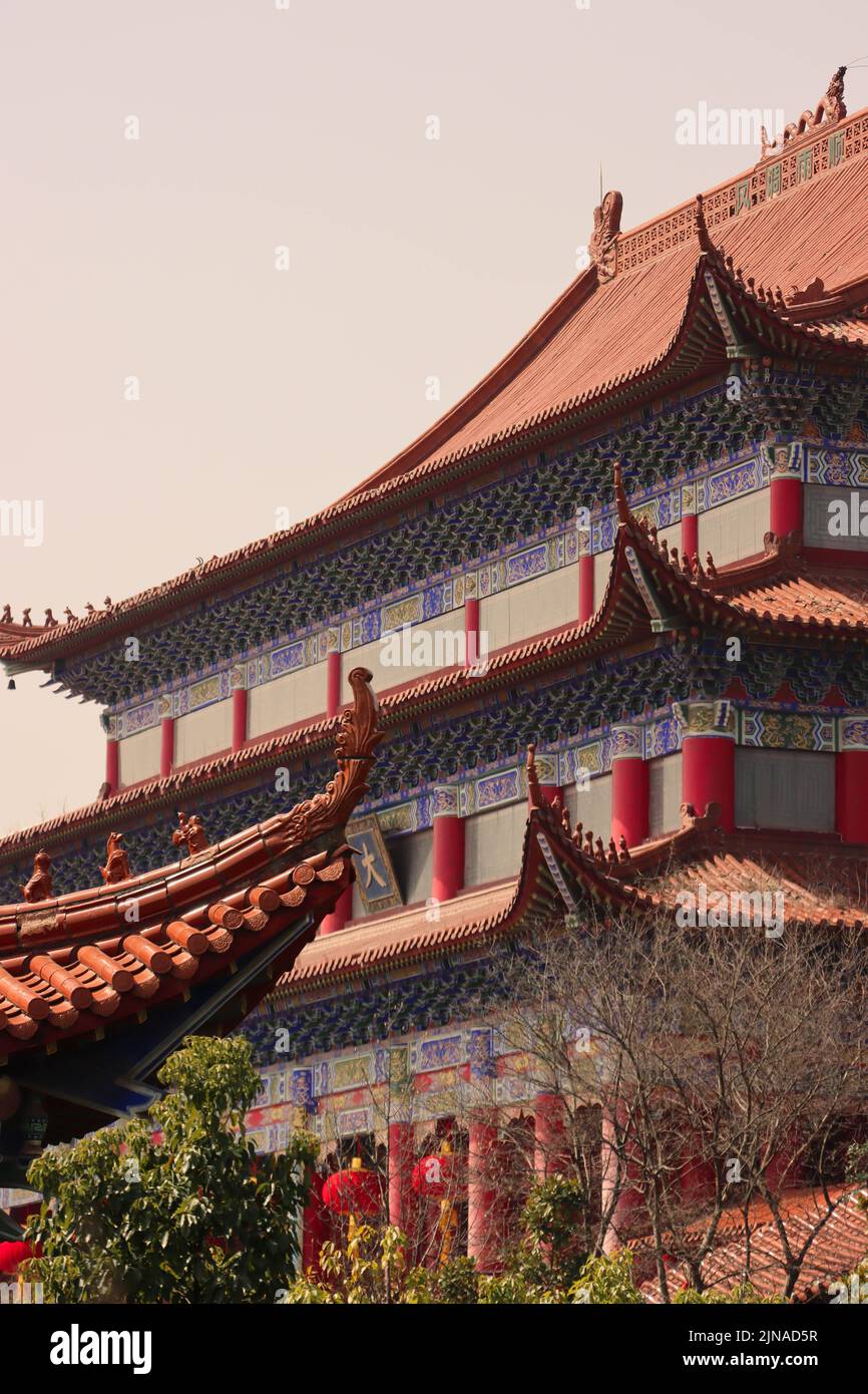 A vertical shot of a Chinese traditional temple with a beautiful roof ...