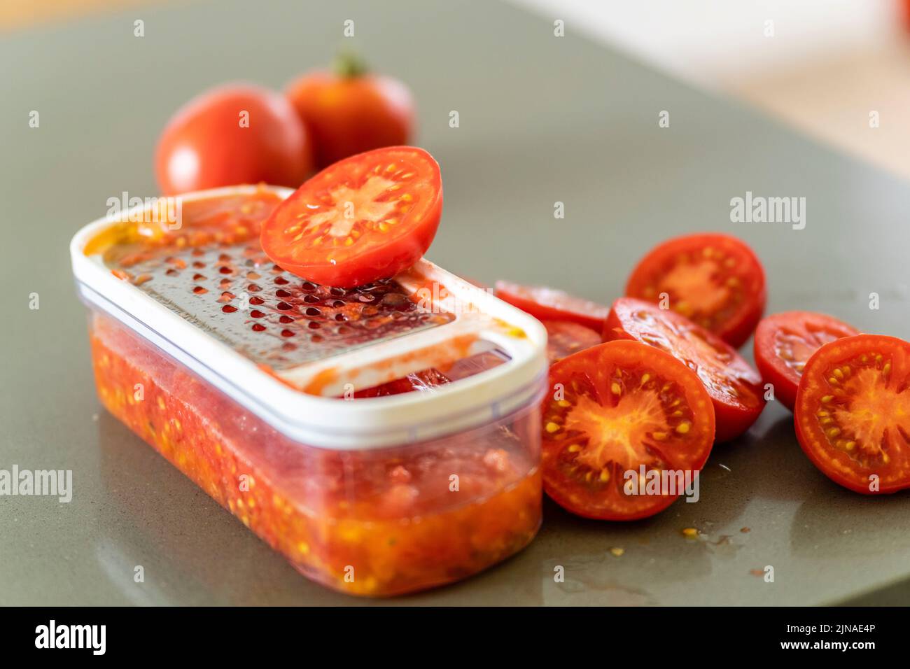 grating tomatoes for sauce, mallorca, spain Stock Photo - Alamy