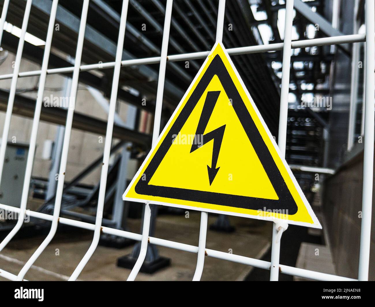 The sign in the yellow triangle is Danger. High voltage on electrical ...