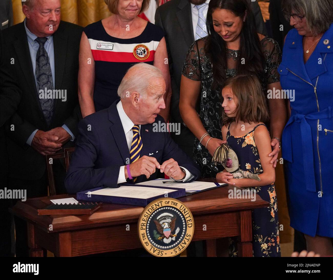 United States President Joe Biden speaks to Brielle Robinson, surviving ...