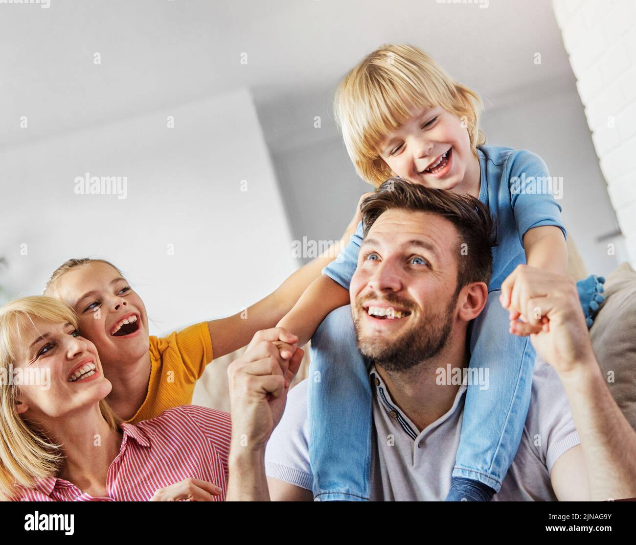 child daughter son family happy mother father sofa playing fun together ...