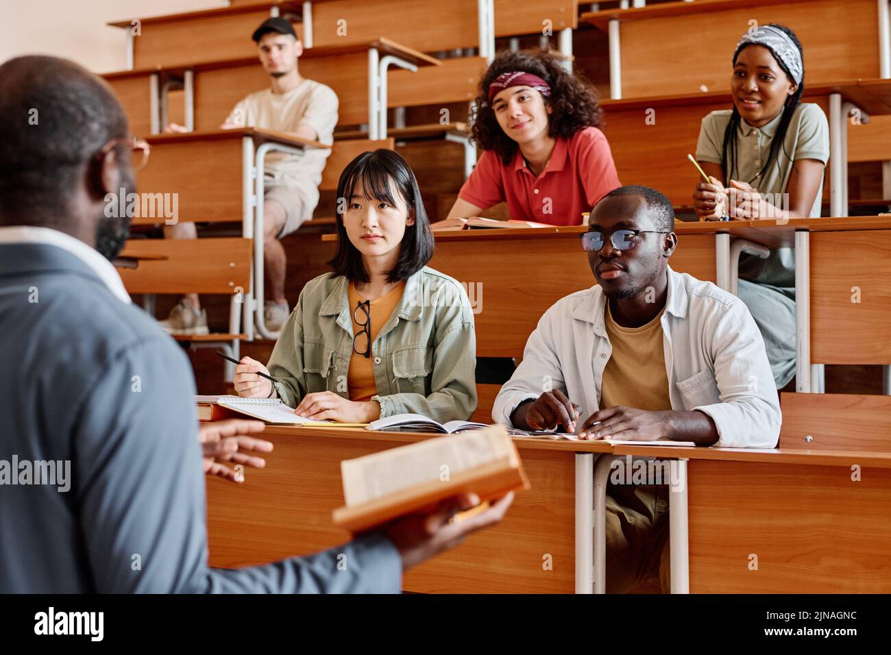 Group of students listening to teacher during lecture at university ...