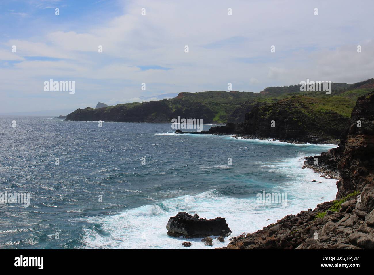 Rocky cliffsides, some covered in vegetation, dropping to the Pacific ...