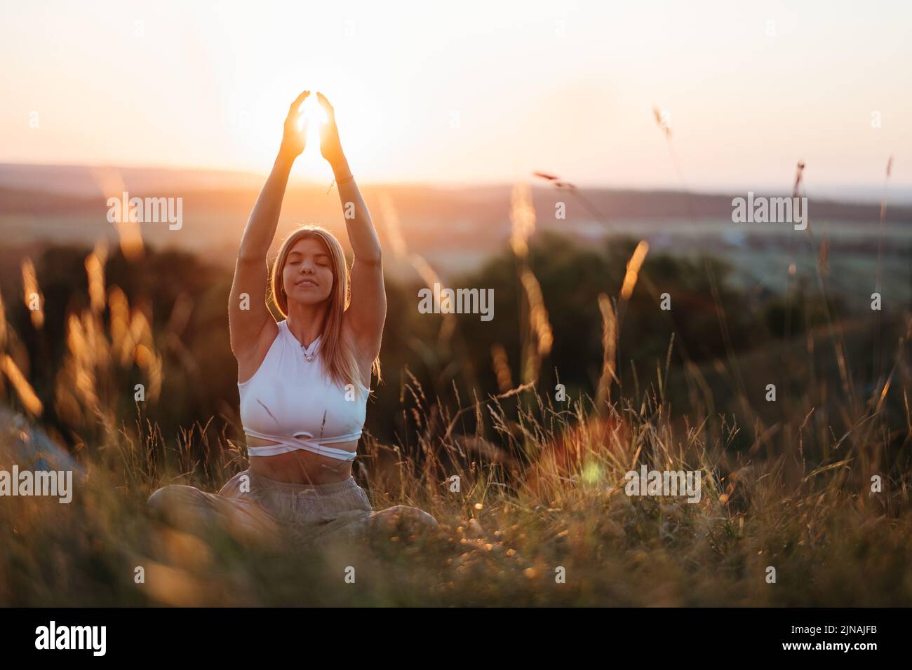 Woman catching the sun hi-res stock photography and images - Alamy