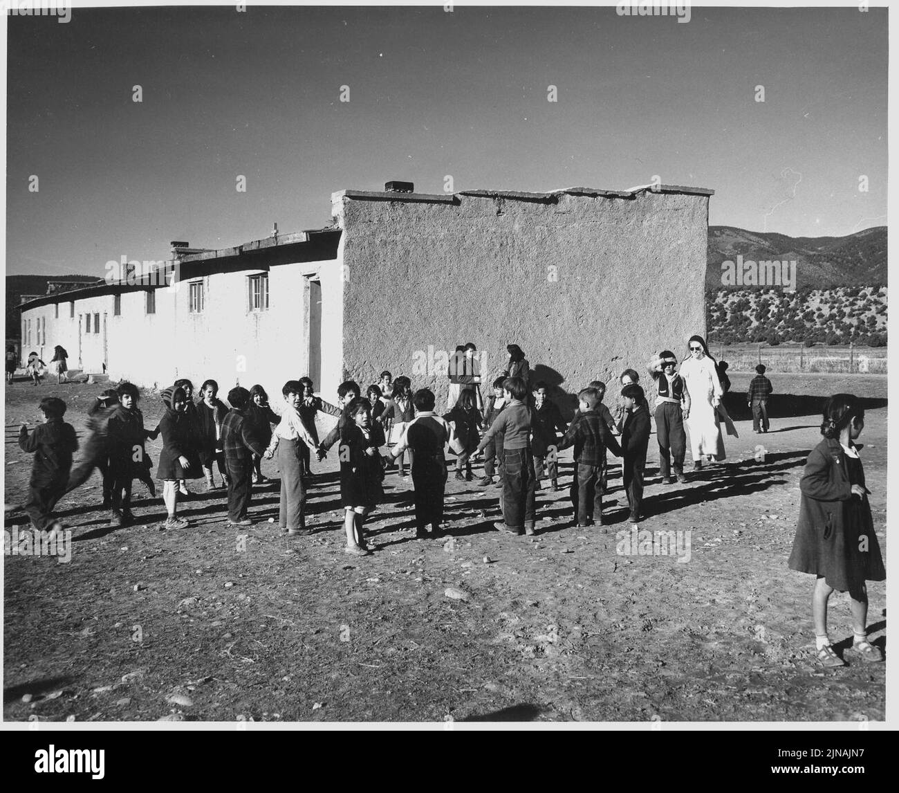 Taos County, New Mexico. Children play in the Penasco schoolyard ...