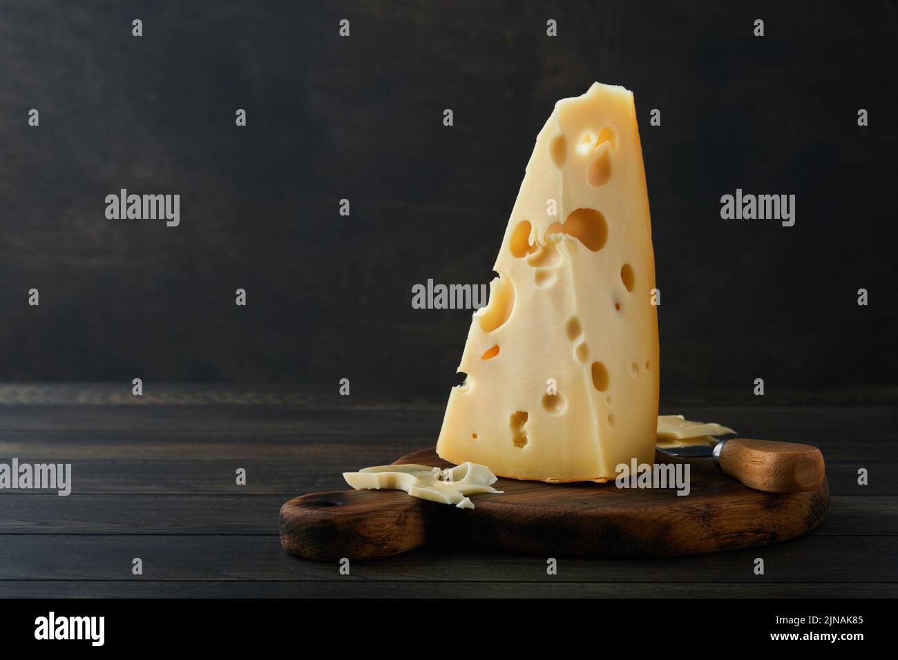 Cheese. Piece of cheese triangle, Swiss cheese on with basil and a ...