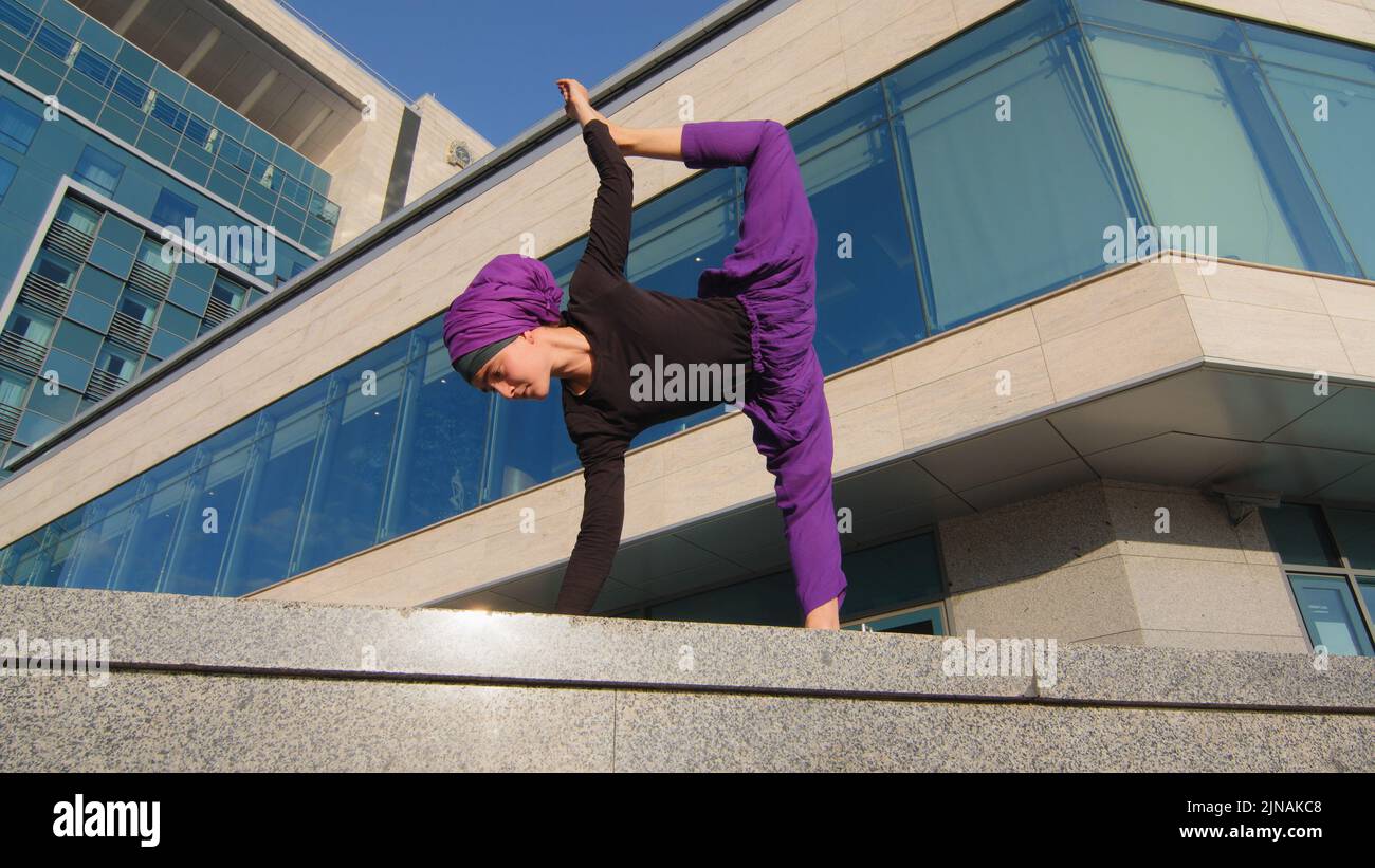 Muslim woman in hijab in city doing workout training strength stretch ...