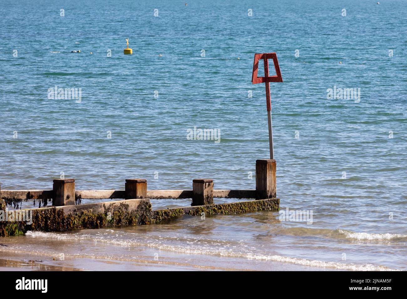 Groyne and marker on Swanage beach in summertime, Dorset, England Stock ...