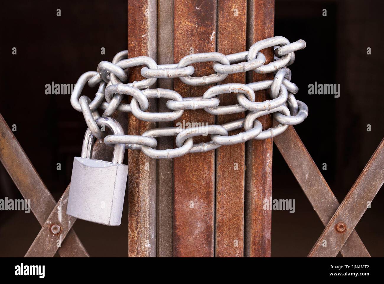 Closeup of a metal gate chained and locked Stock Photo - Alamy