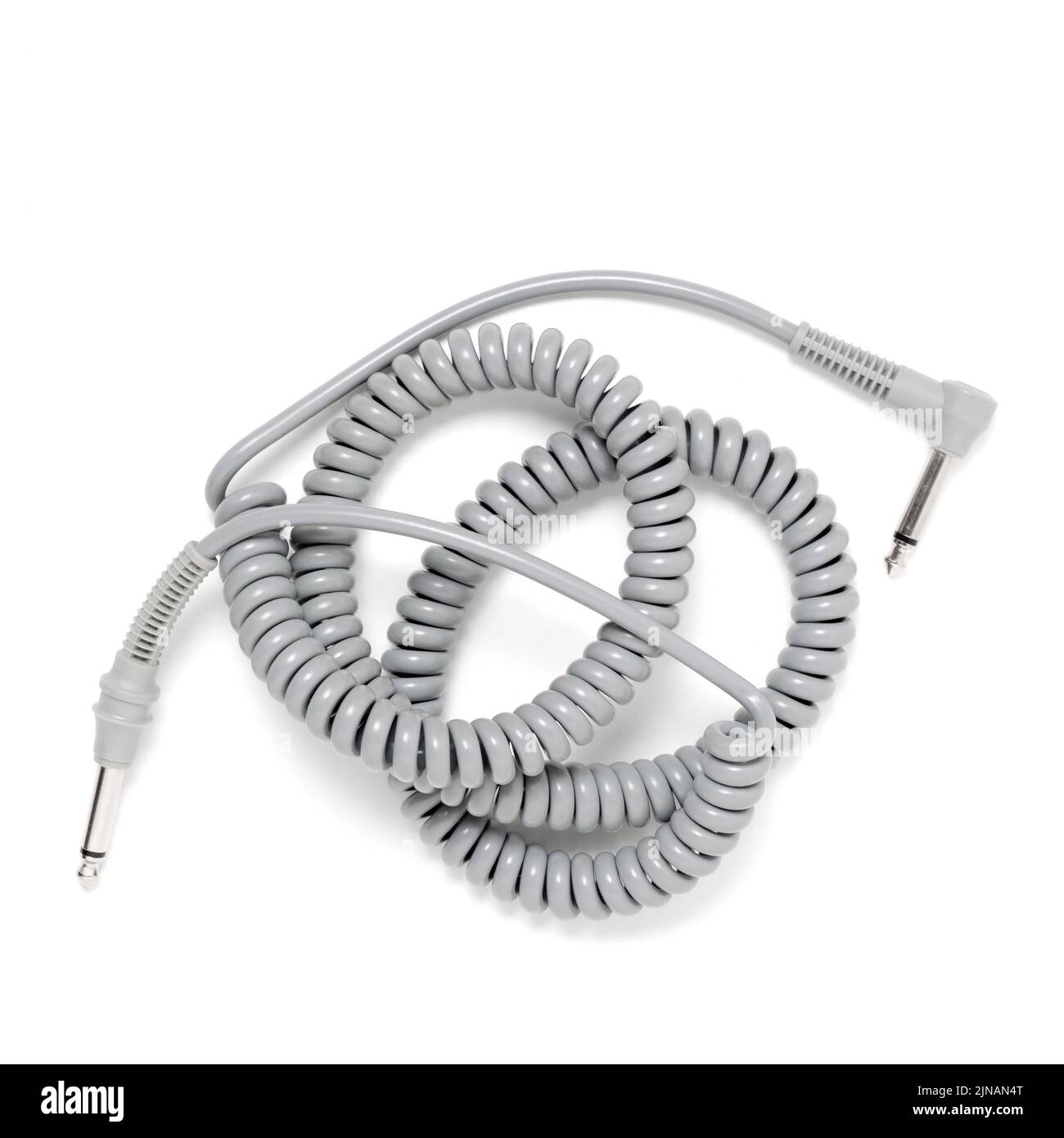 Old style curly instrument cable or cord on white background Stock ...