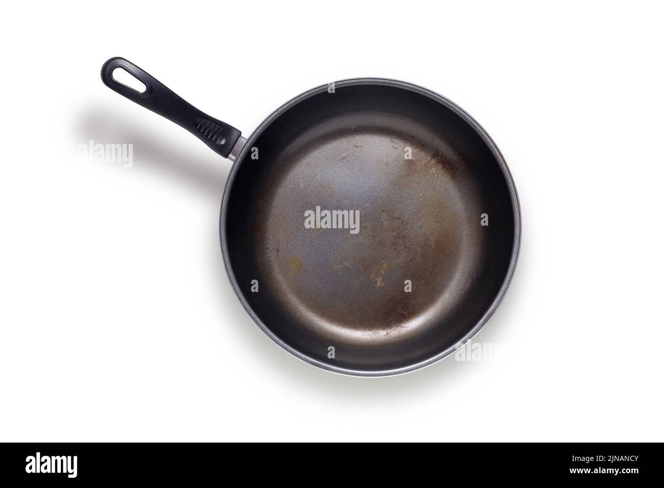 Dirty frying pan showing burnt on cooking stains shot from above ...