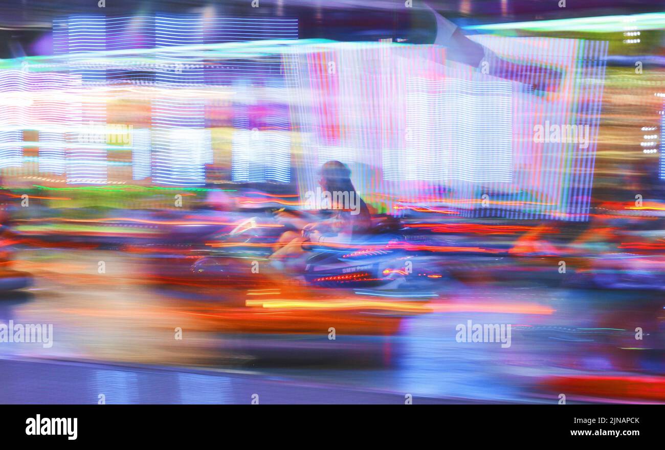 Nocturnal long exposure tracking a bumper car running fast in a track ...