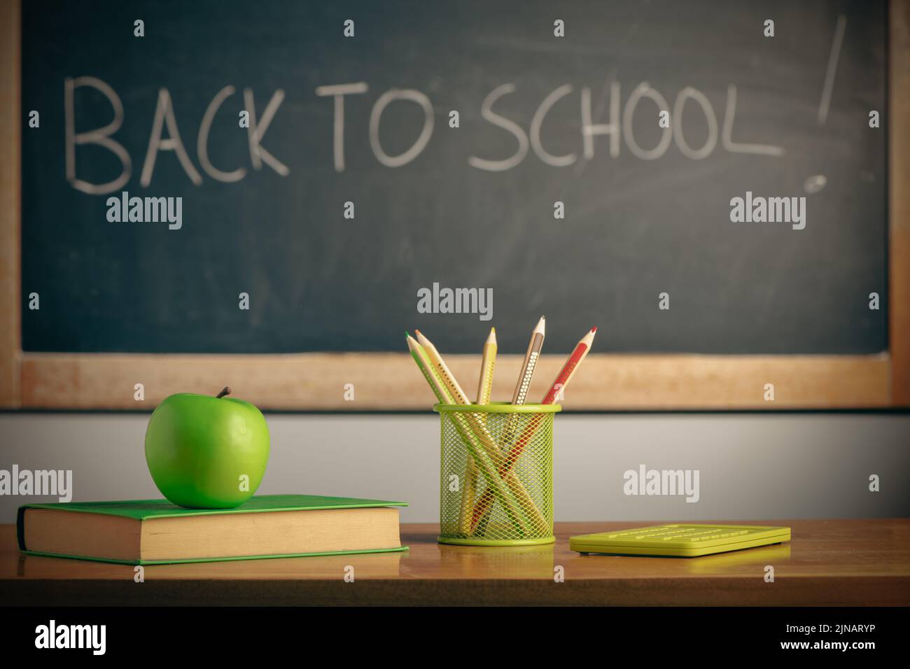 Apple on a book on blackboard background. Education concept back to ...
