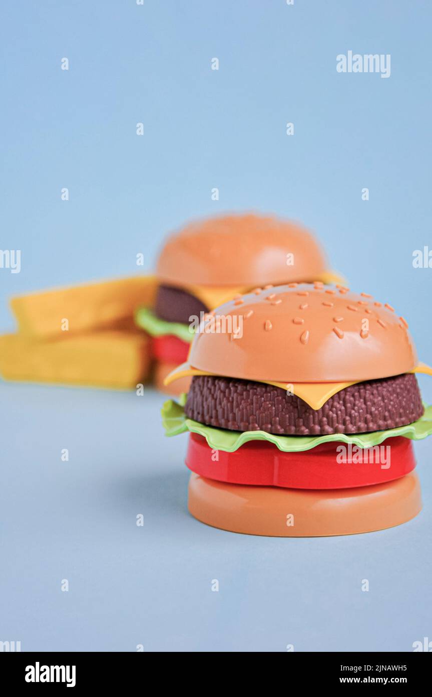 Plastic childrens toy burger with salad, tomato, meat and French fries ...